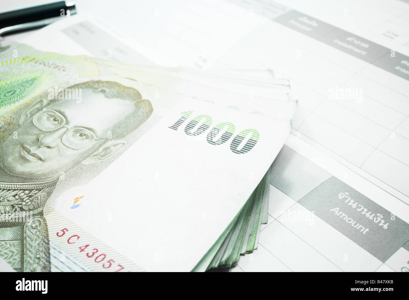 Thai money banknote on record table note book Stock Photo - Alamy