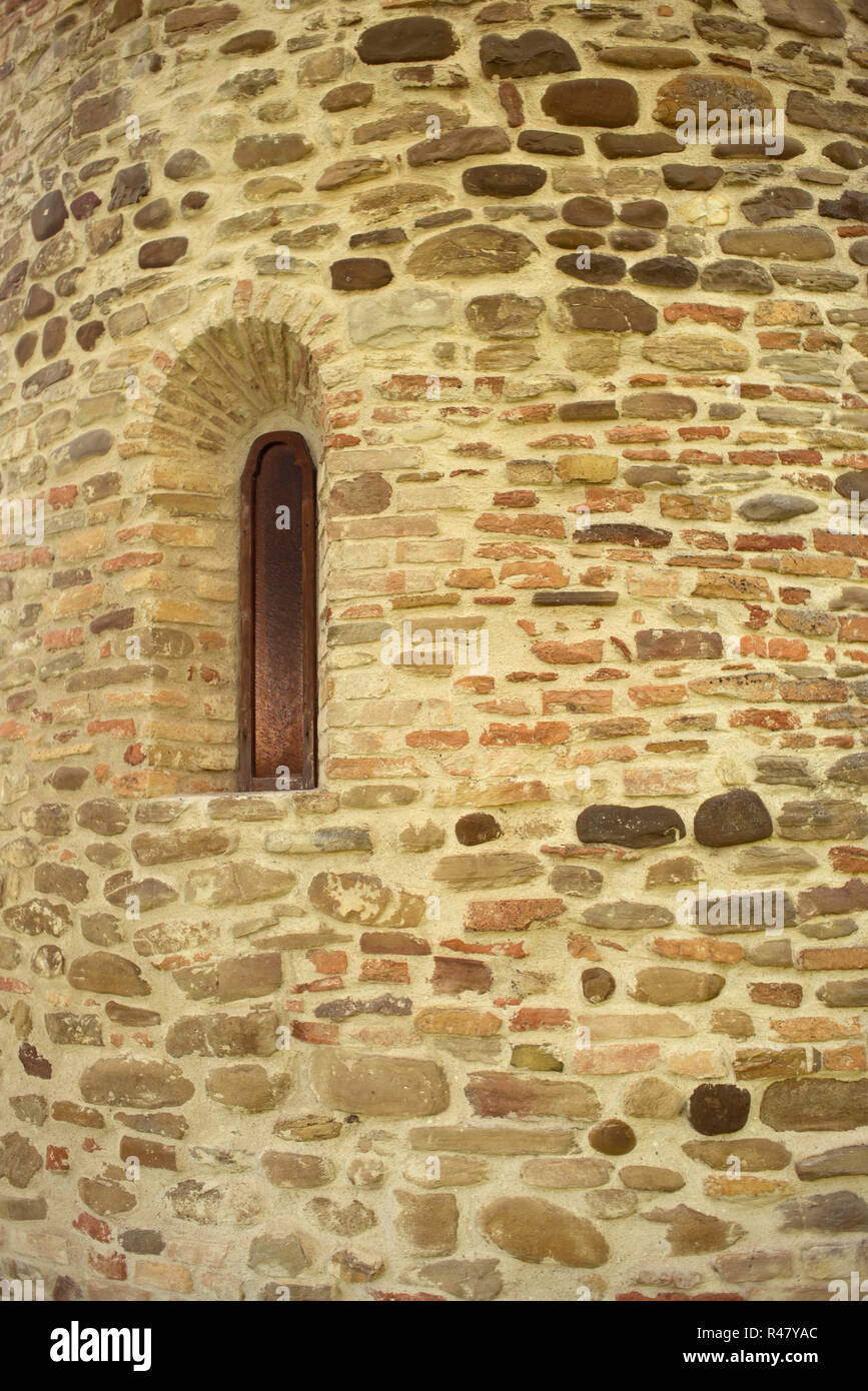 Long vertical window of old church San Paterniano 1600, in a remote ...