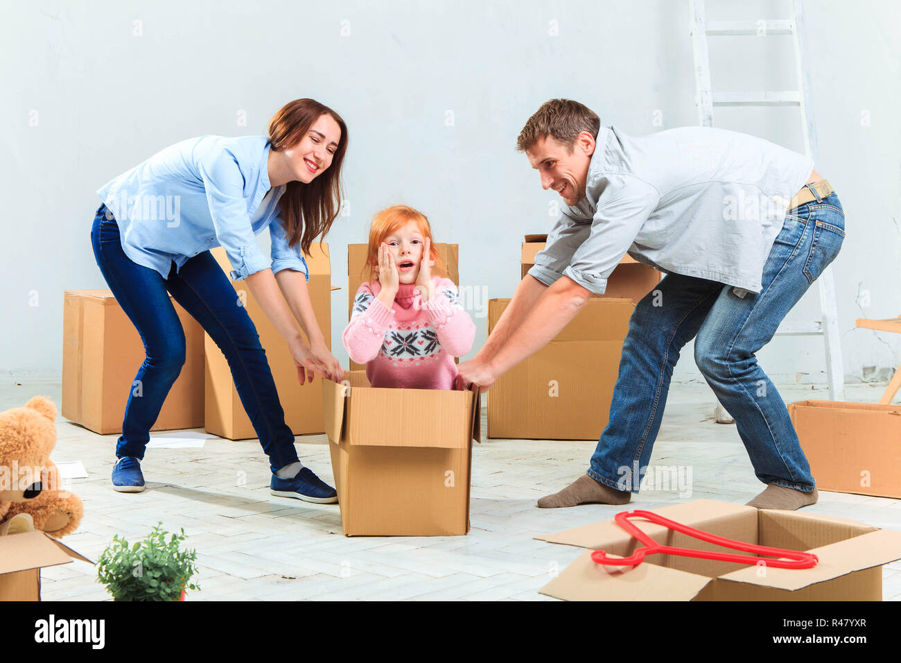 The happy family during repair and relocation Stock Photo - Alamy