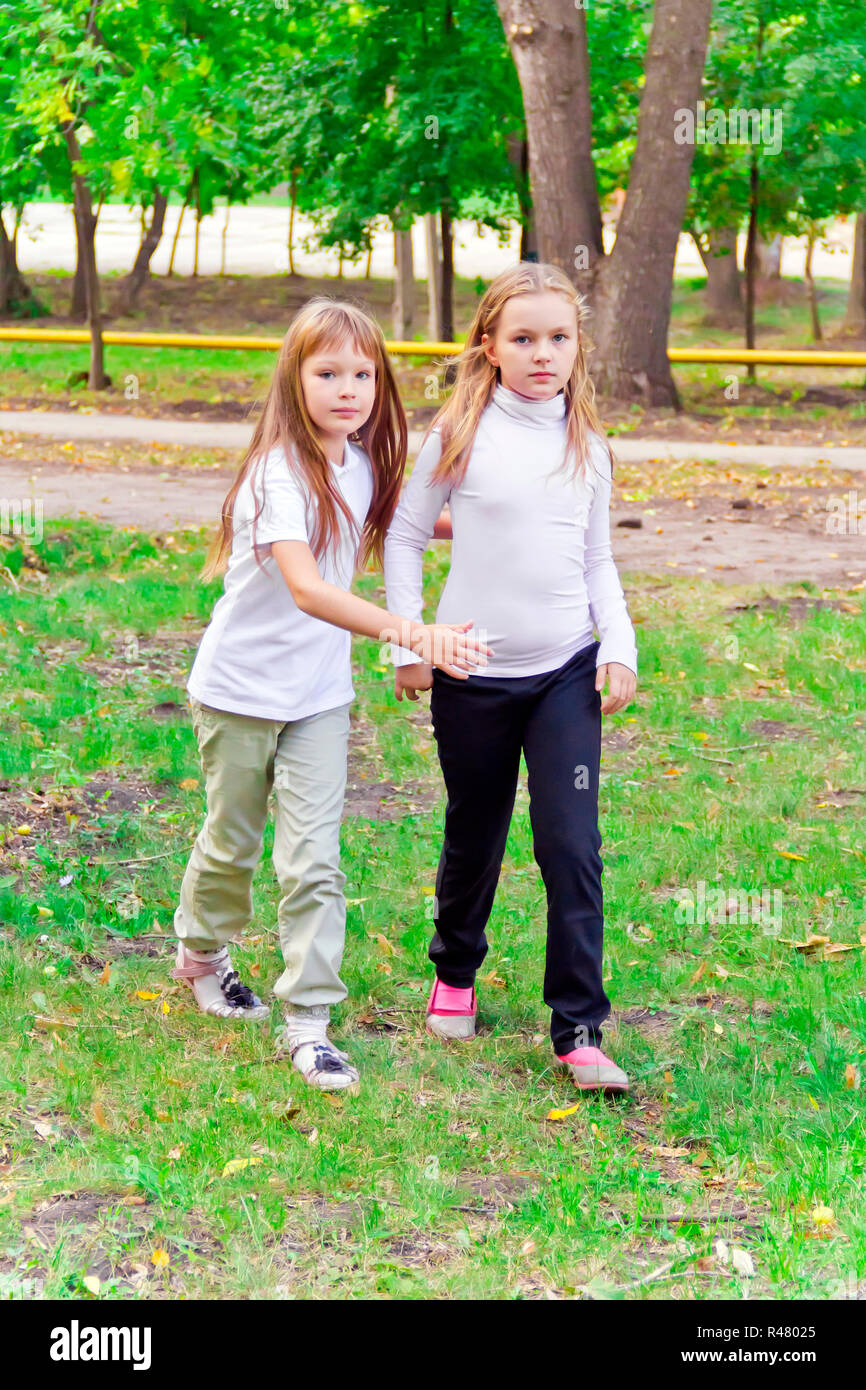 Cute two walking girls Stock Photo - Alamy