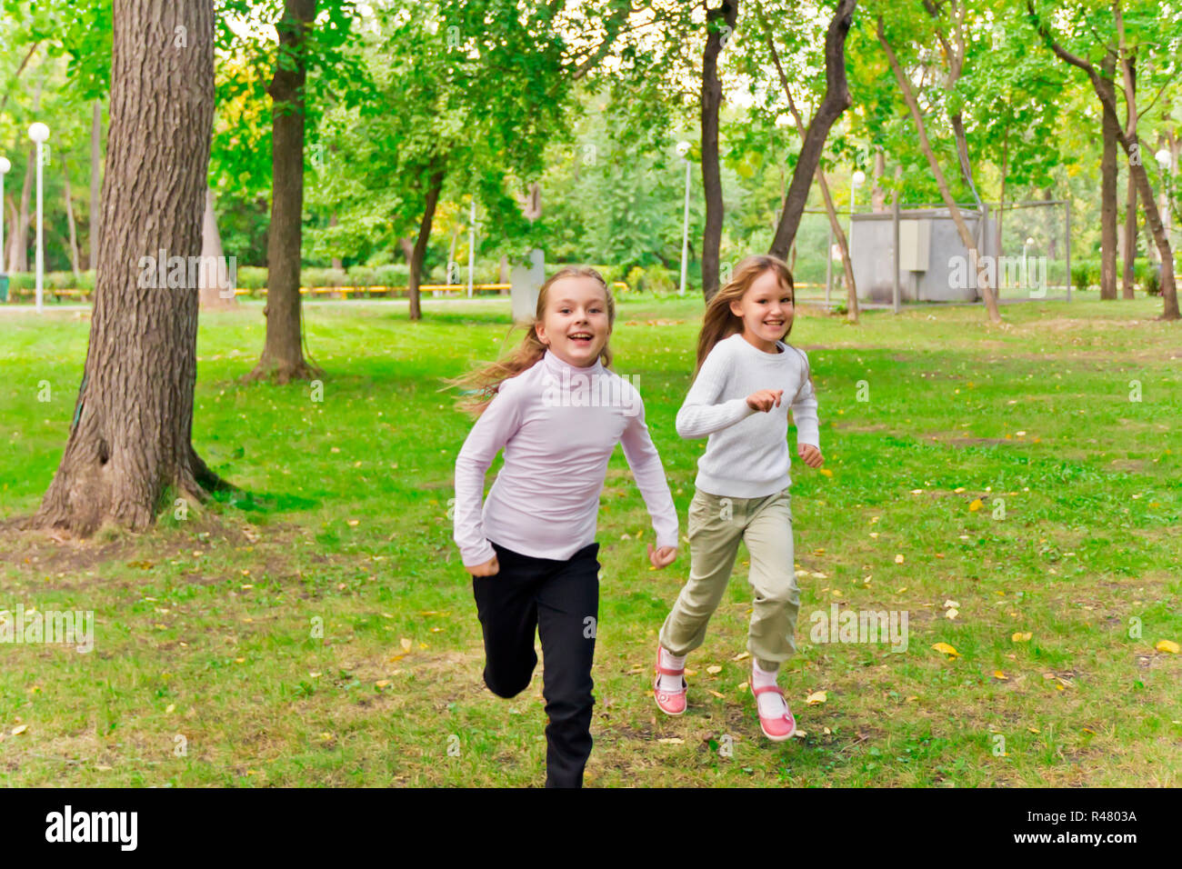 Cute two running girls Stock Photo - Alamy