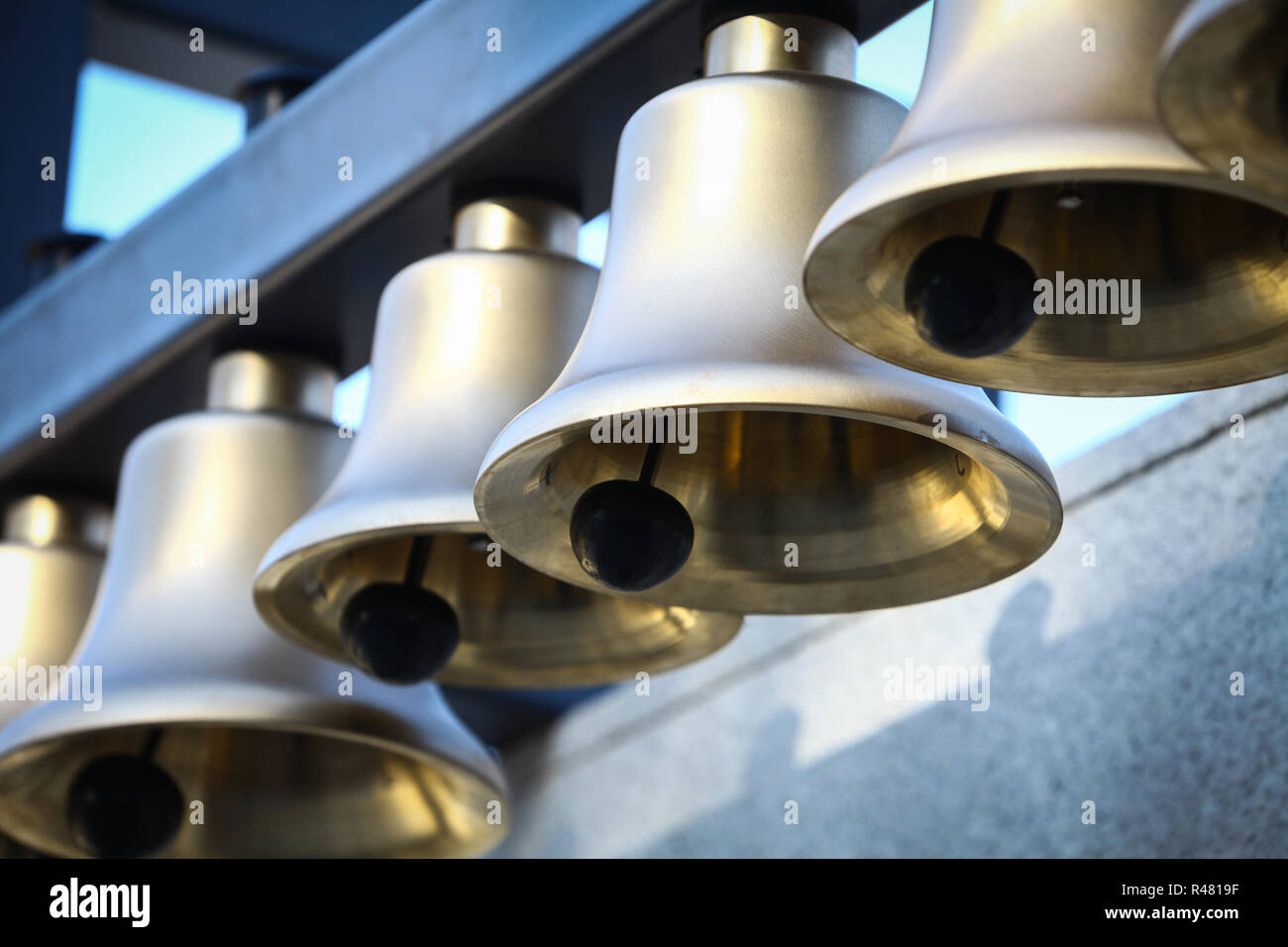 Various bells in a row Stock Photo - Alamy