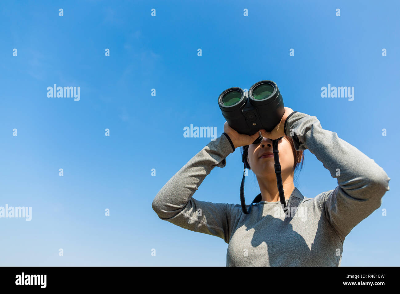Woman use the binoculars Stock Photo - Alamy