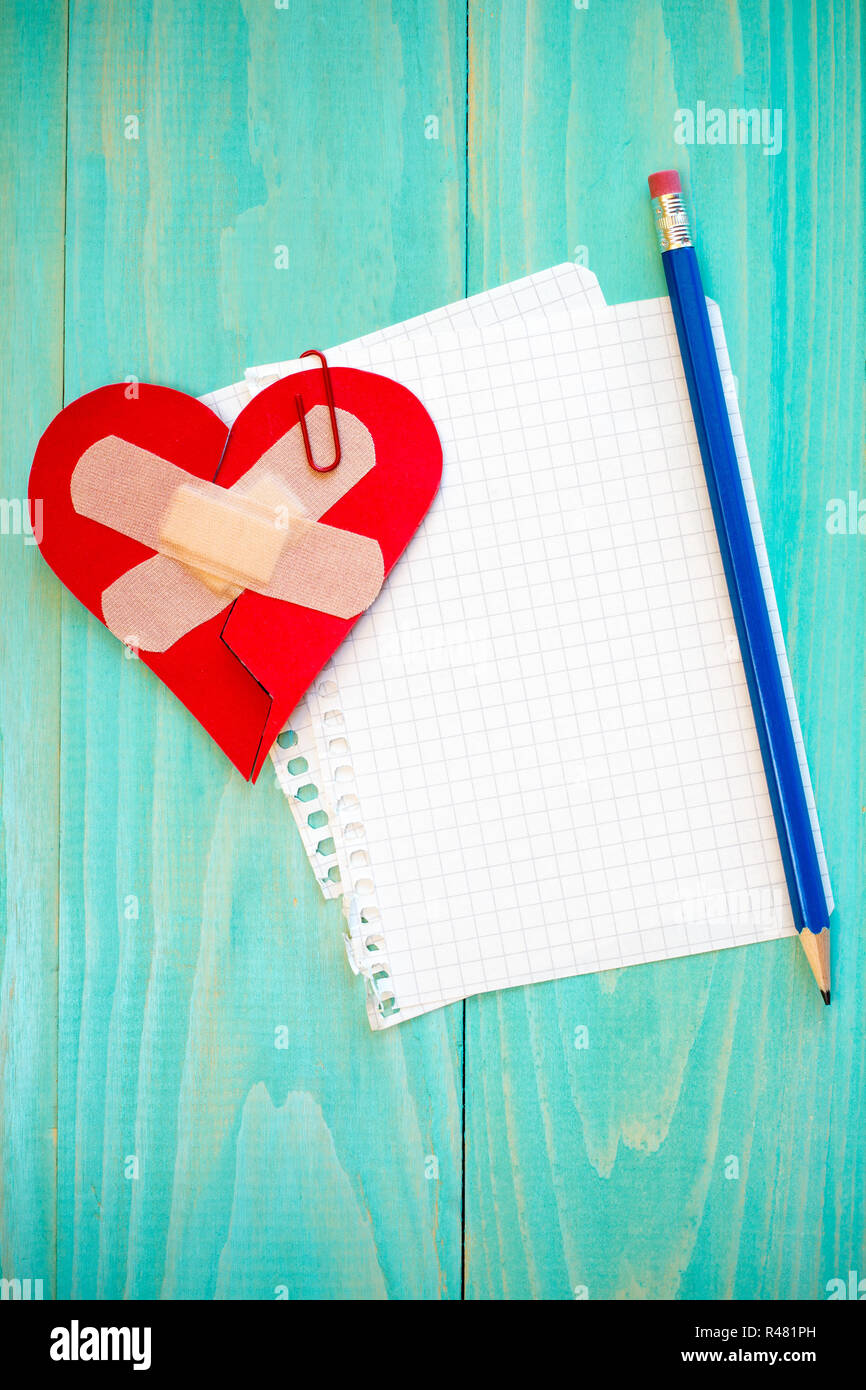 Broken heart with sheet of paper Stock Photo - Alamy