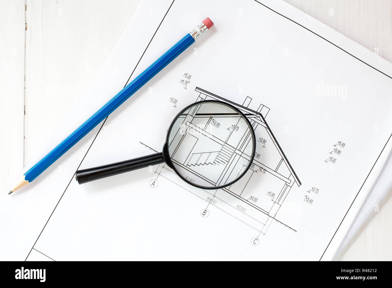 Drawings with pencil and magnifier Stock Photo - Alamy