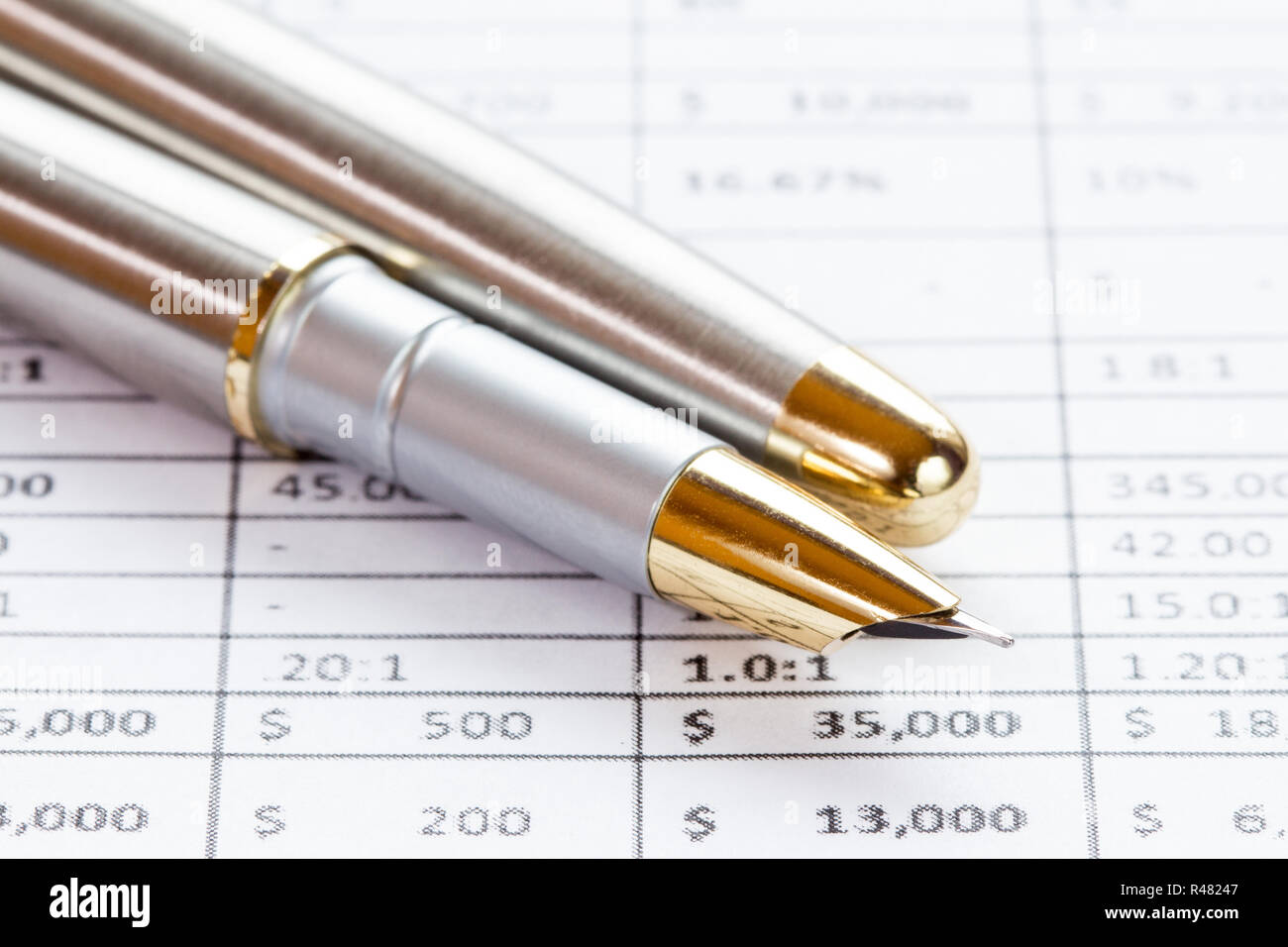 Image of financial report with pen Stock Photo - Alamy