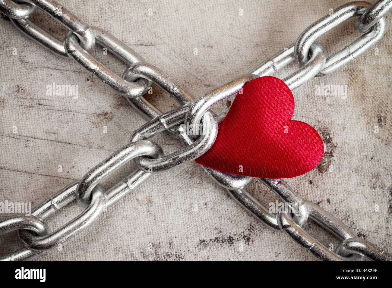 Crossed chains with red heart Stock Photo - Alamy