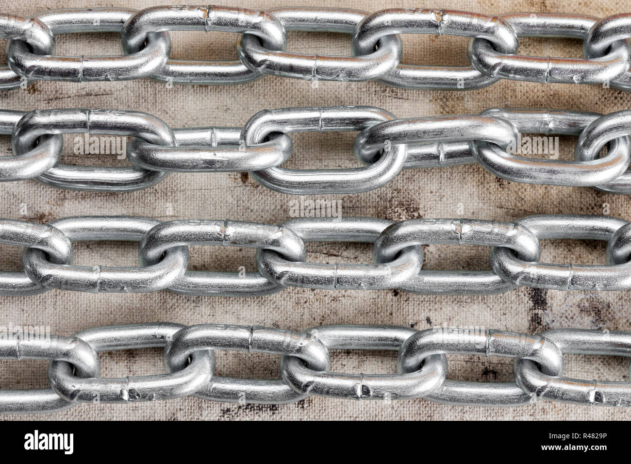 Four chains crossing dirty background Stock Photo - Alamy