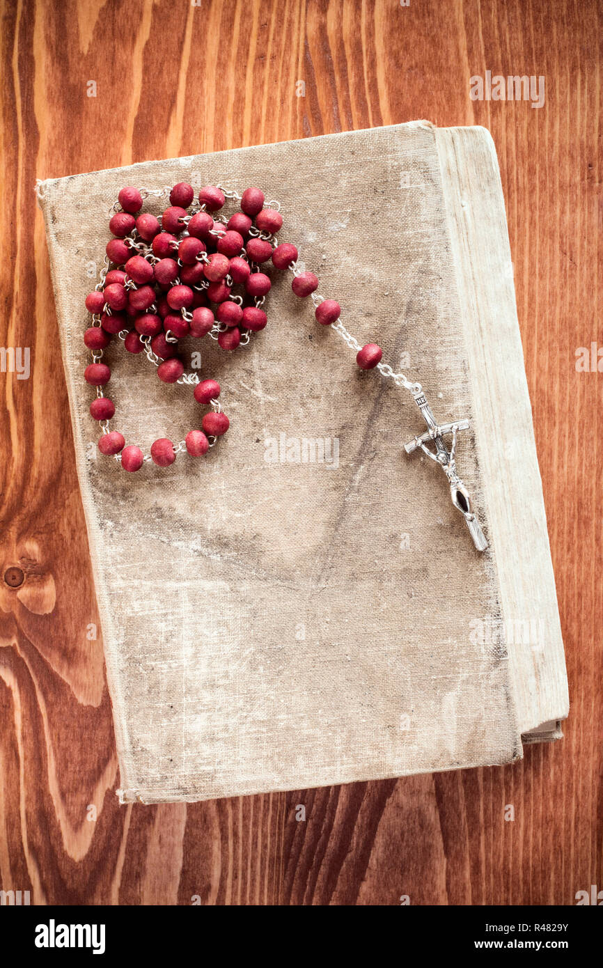 Old book and catholic rosary Stock Photo - Alamy