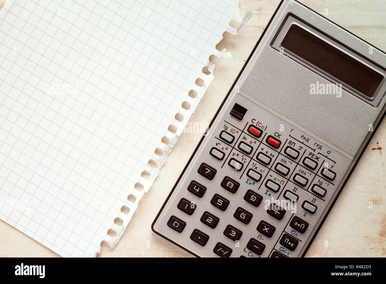 Old calculator and blank square paper Stock Photo - Alamy