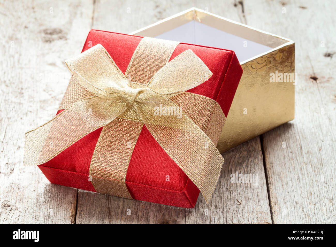 Open gift box with golden ribbon Stock Photo - Alamy