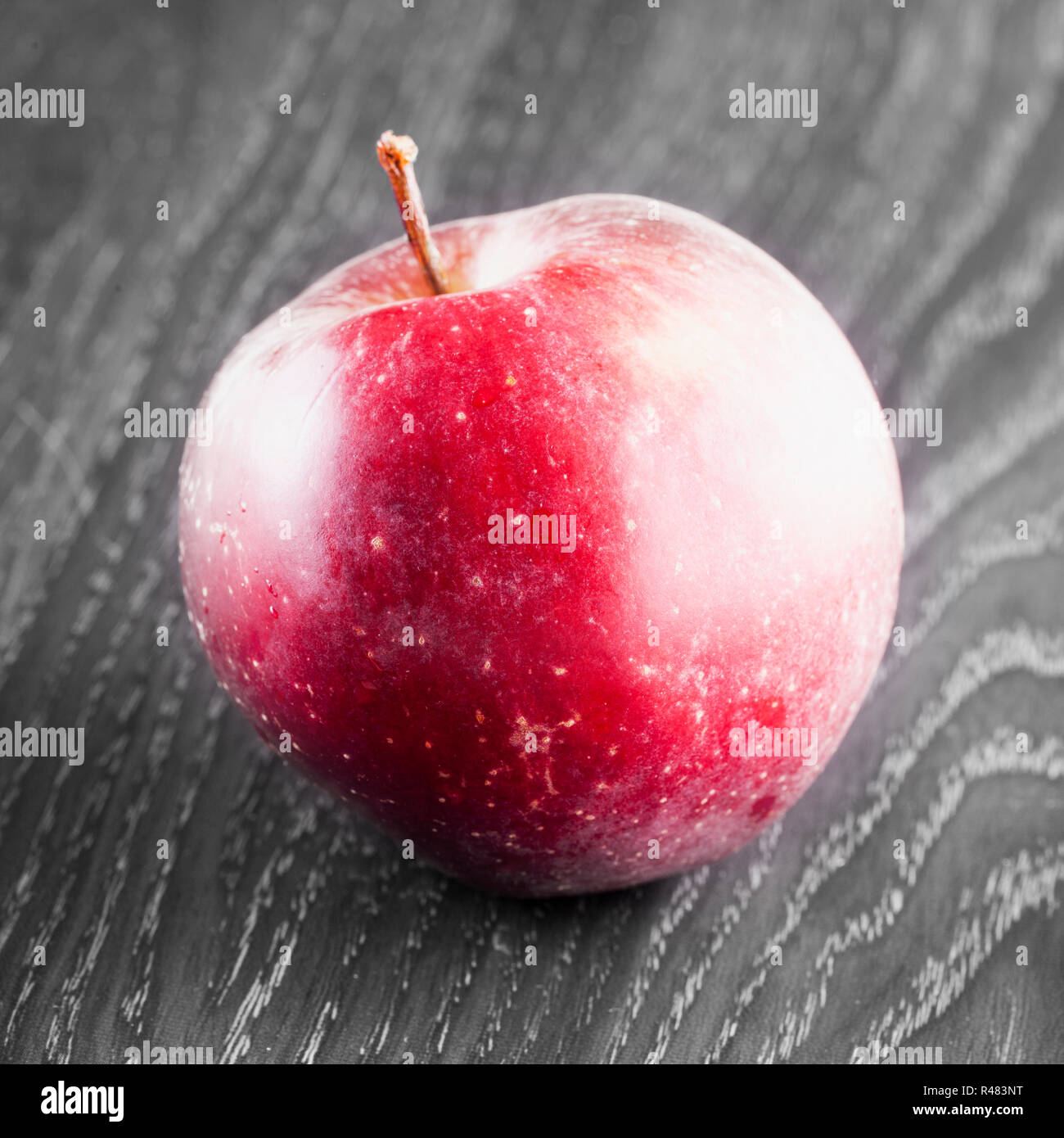Red apple over black and white background Stock Photo - Alamy