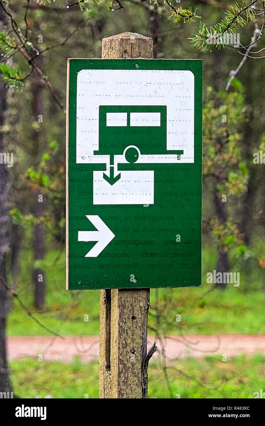 A green sani-dump sign with a direction arrow Stock Photo - Alamy