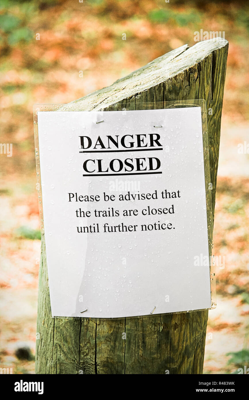 Closeup of a danger hiking trails closed sign Stock Photo - Alamy