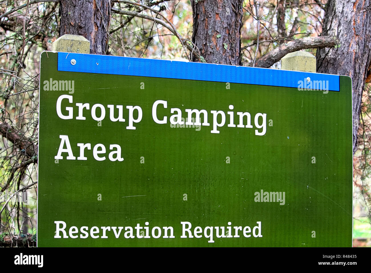A group camping area sign indicating reservations are required Stock ...