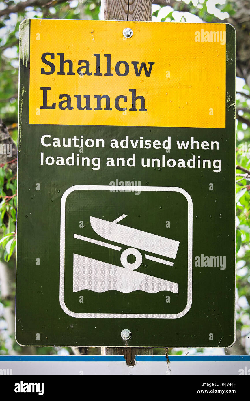 A shallow boat launch sign advising caution Stock Photo - Alamy
