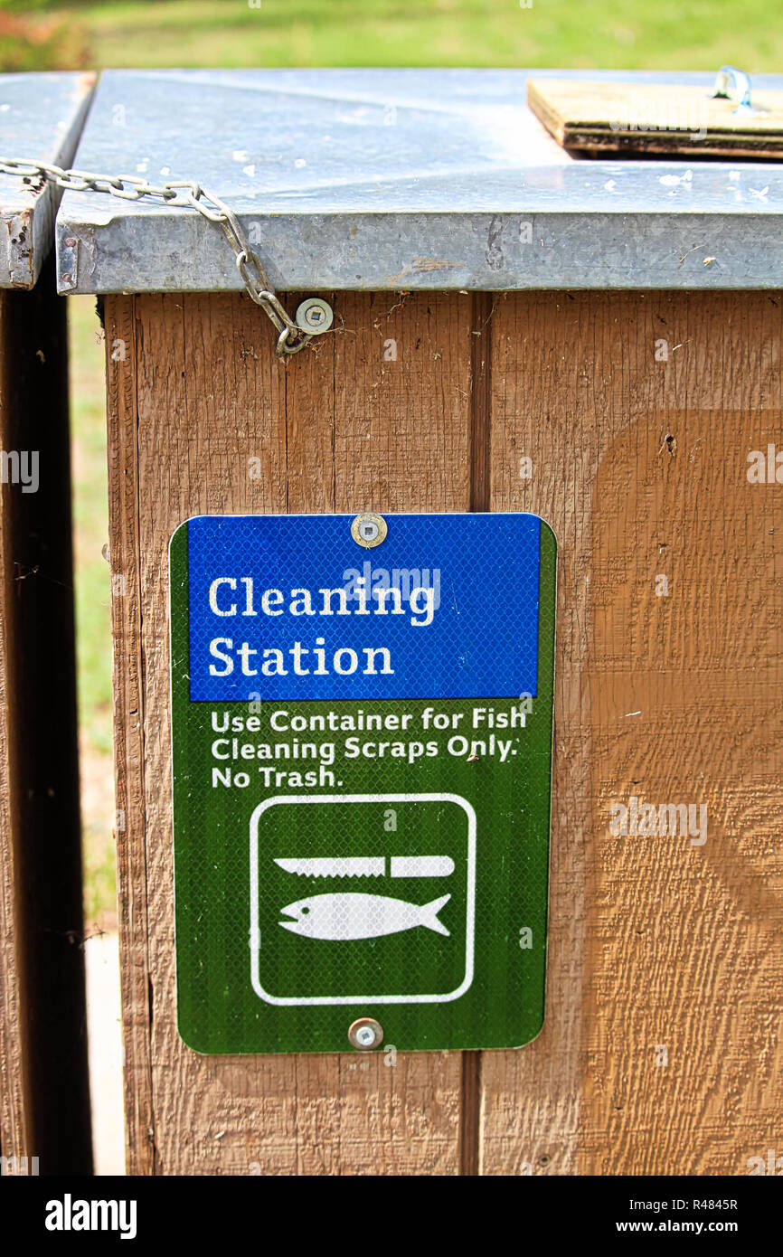 A cleaning station sign indicating container only for fish scraps Stock ...