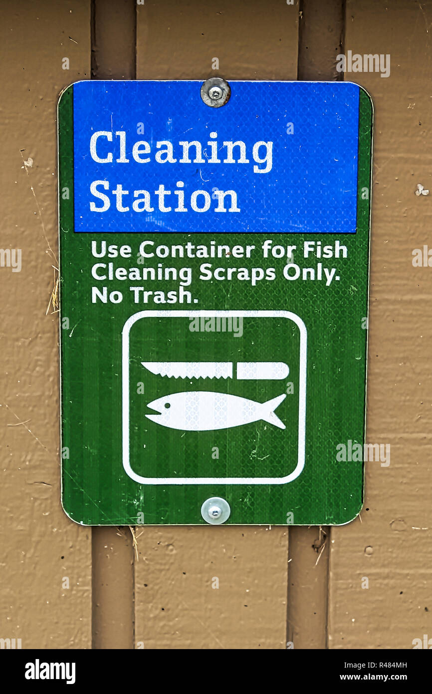 A cleaning station sign indicating container only for fish scraps Stock ...