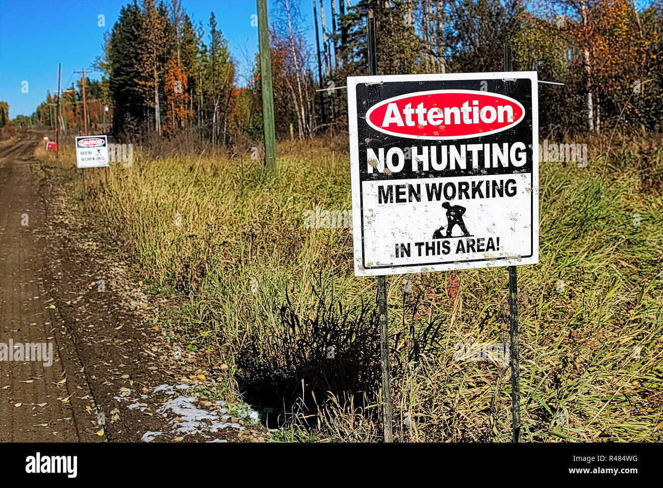 An attention no hunting, men working sign Stock Photo - Alamy
