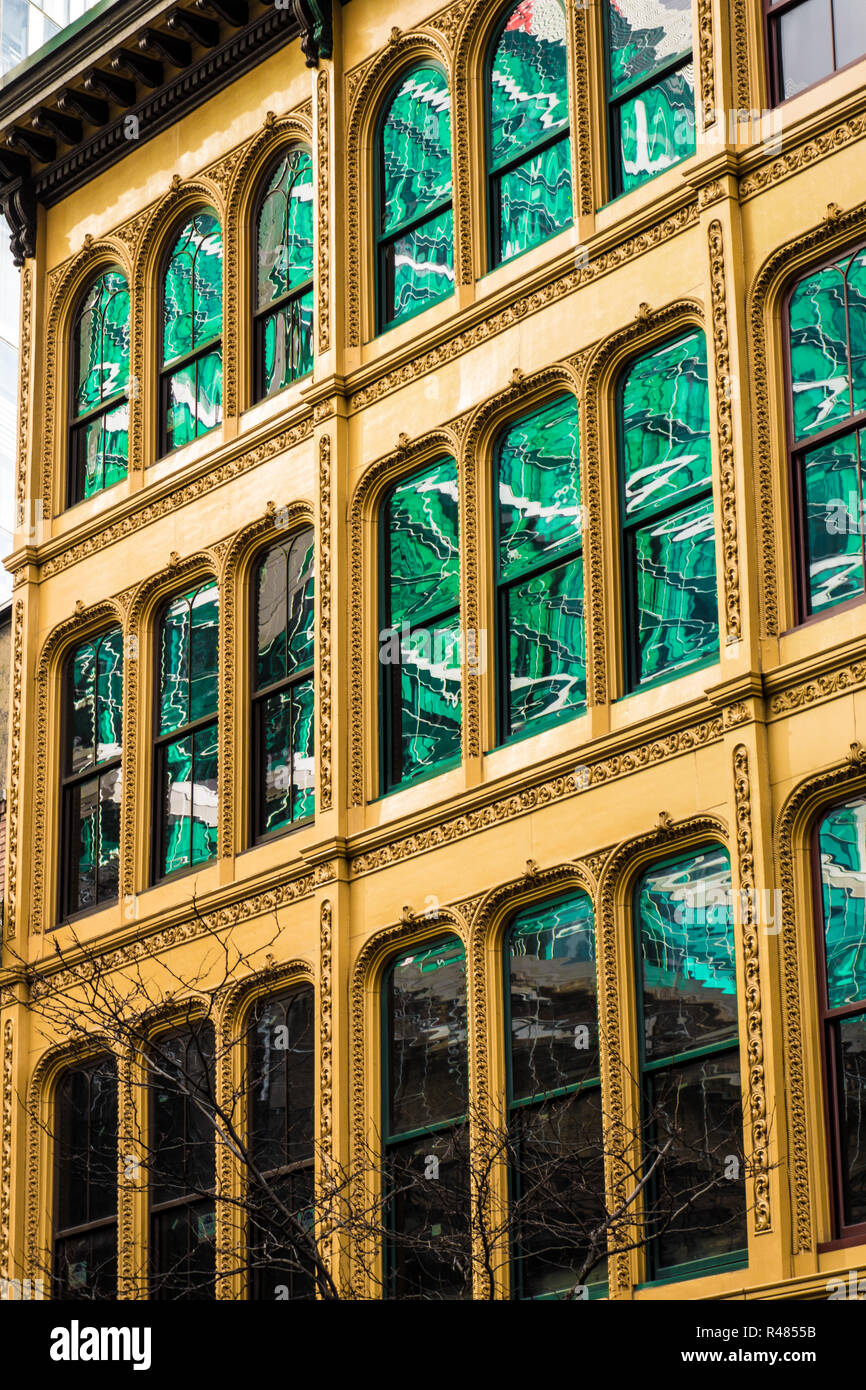Green is reflected in the windows of this historic building along ...