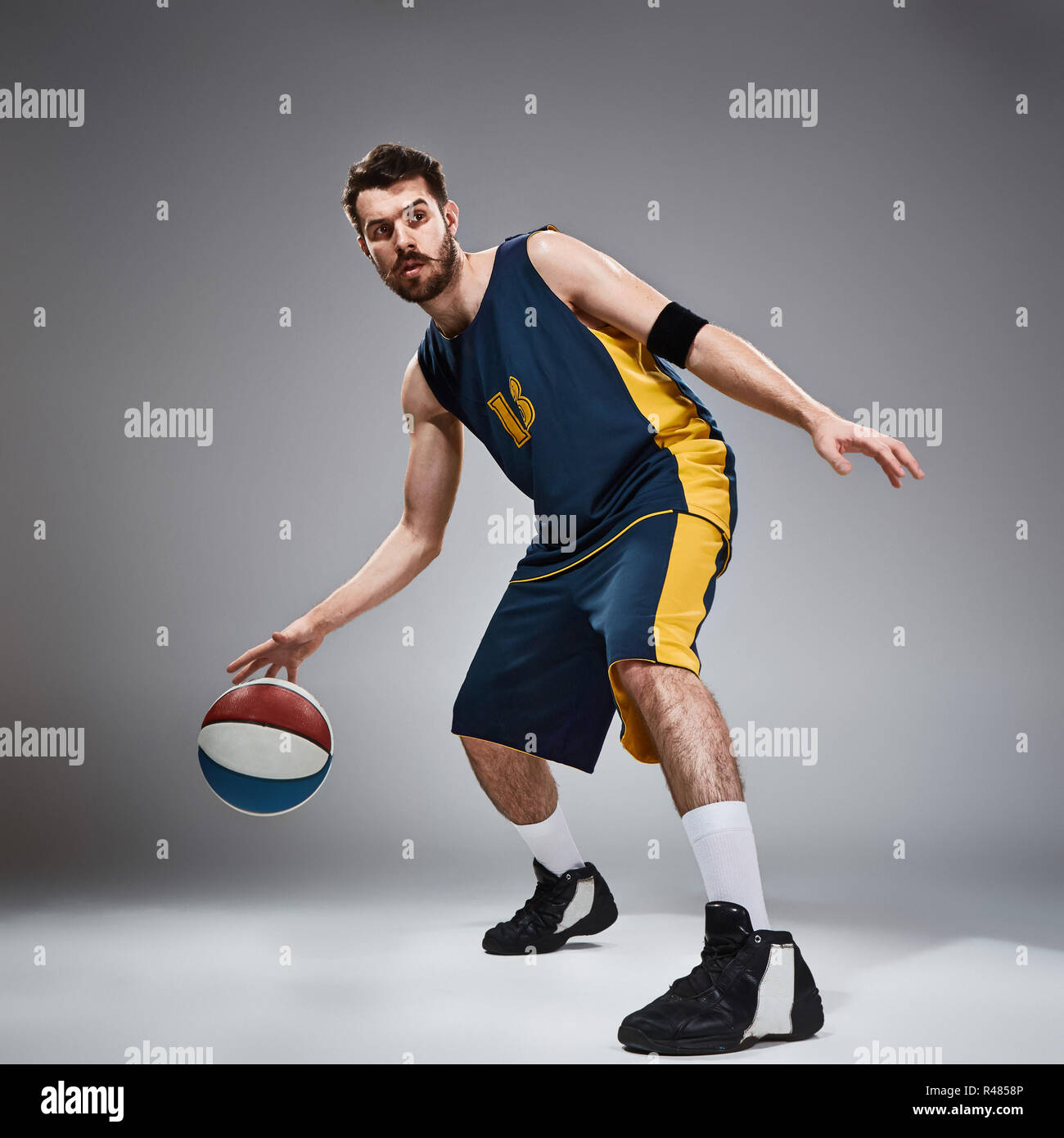 Full length portrait of a basketball player with ball Stock Photo - Alamy