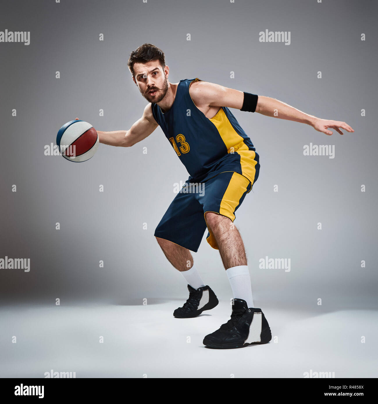 Full length portrait of a basketball player with ball Stock Photo - Alamy
