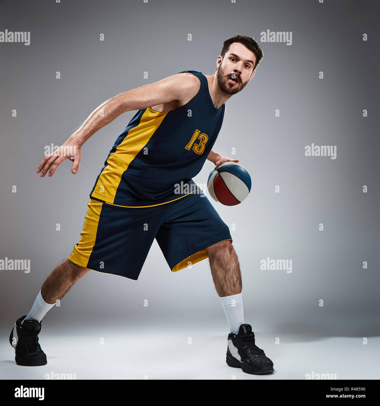 Full length portrait of a basketball player with ball Stock Photo - Alamy