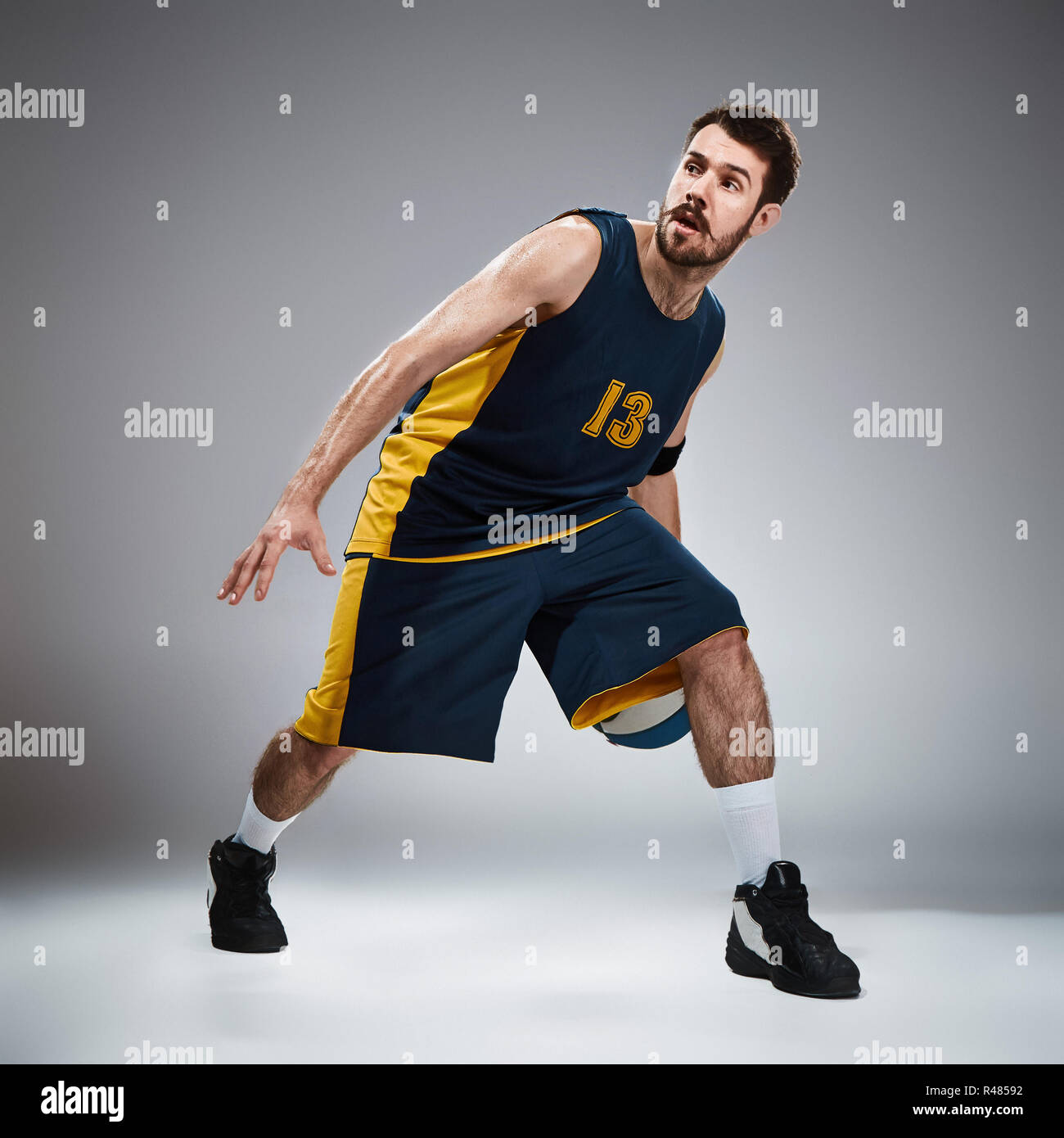 Full length portrait of a basketball player with ball Stock Photo - Alamy
