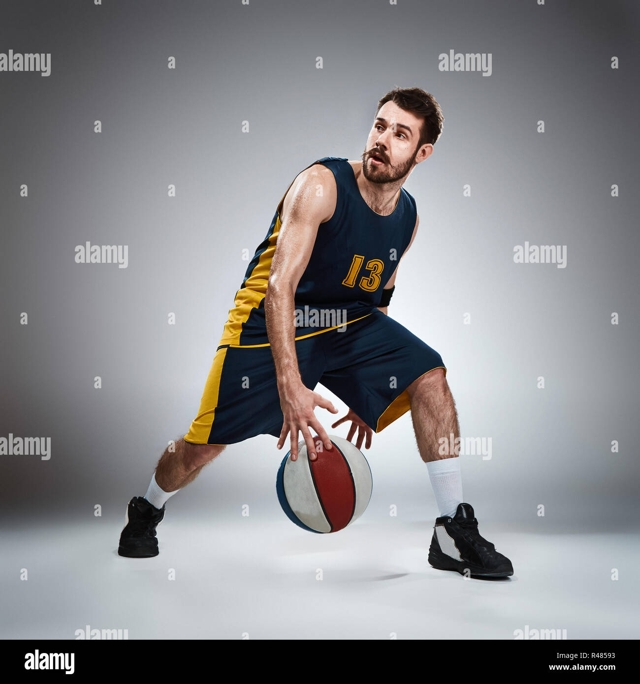 Full length portrait of a basketball player with ball Stock Photo - Alamy