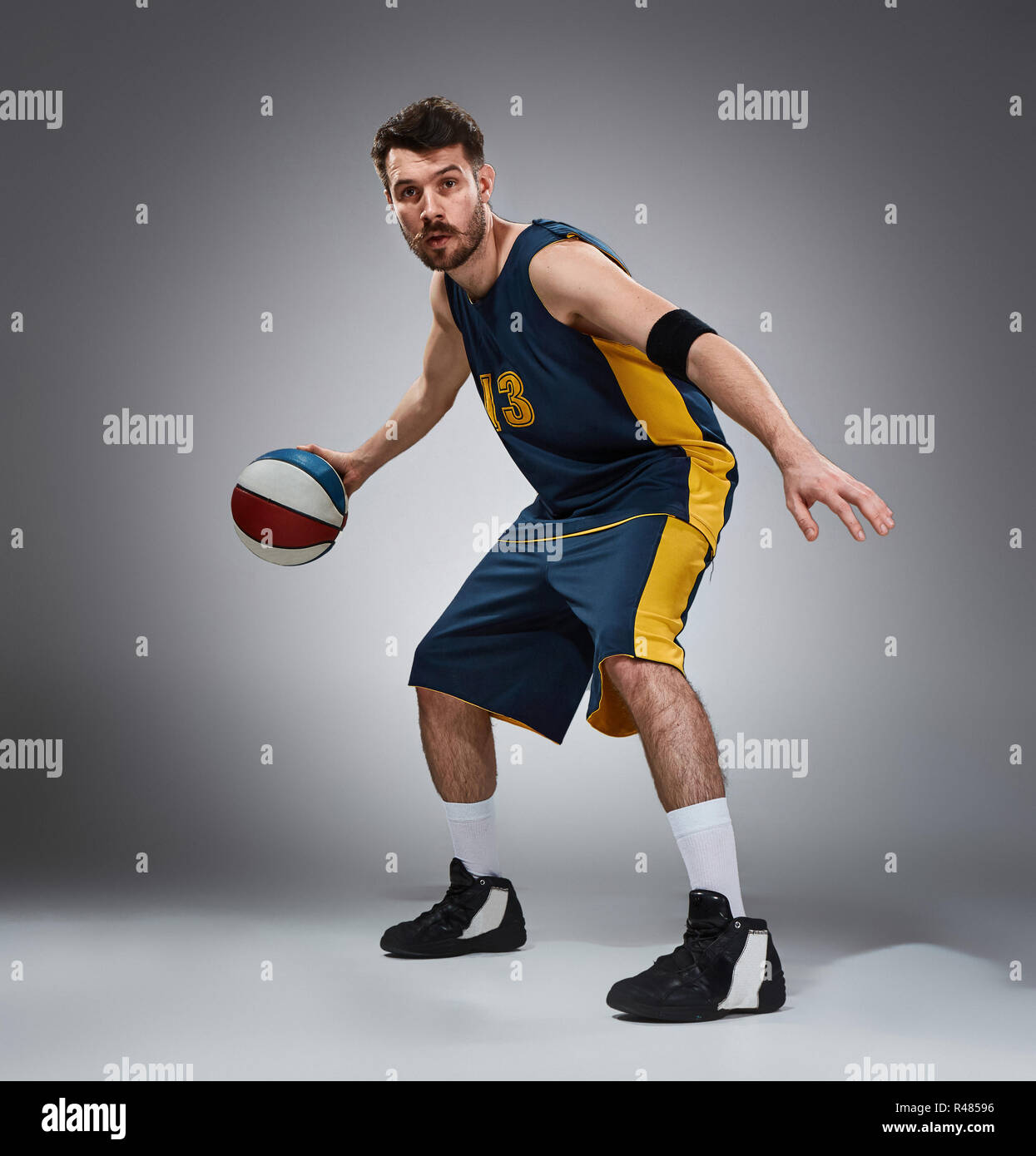 Full length portrait of a basketball player with ball Stock Photo - Alamy