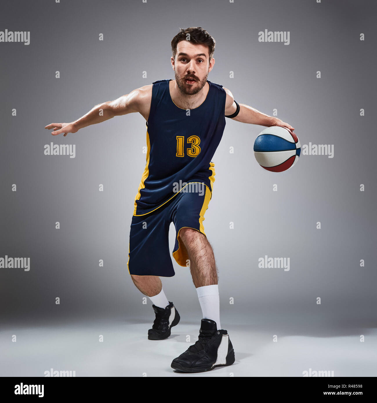 Full length portrait of a basketball player with ball Stock Photo - Alamy