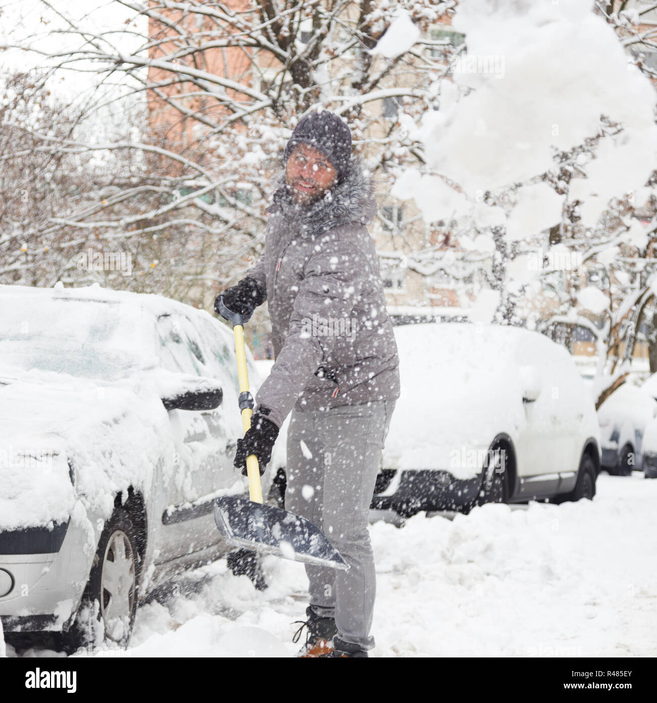 Man shoveling snow in winter Stock Photo - Alamy