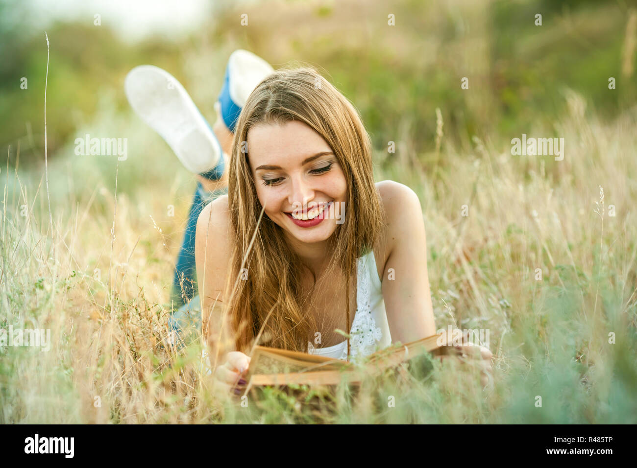 Beautiful girl reading a book on the Nature Stock Photo - Alamy