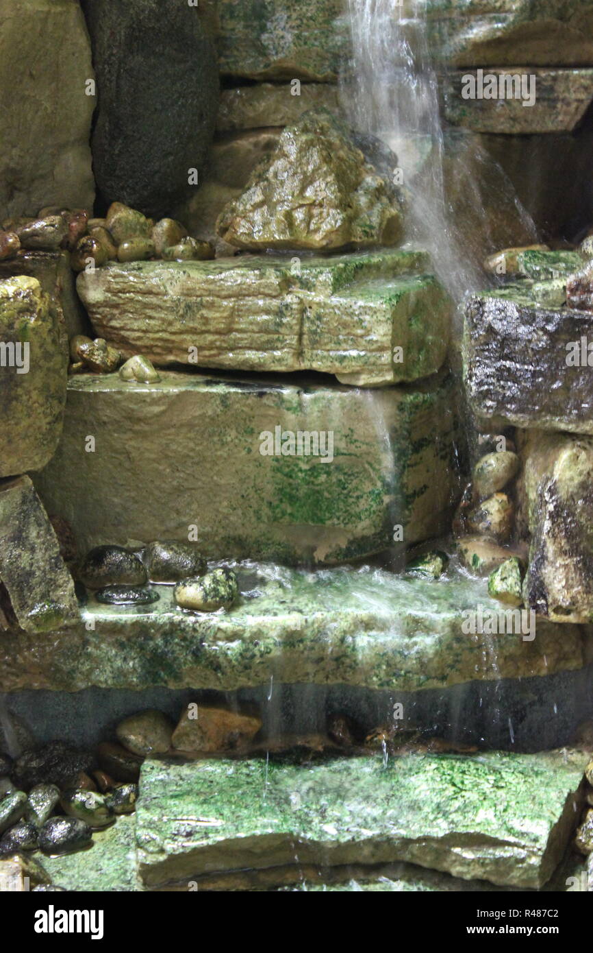 Beautiful man-made waterfall with rocks and stones Stock Photo - Alamy