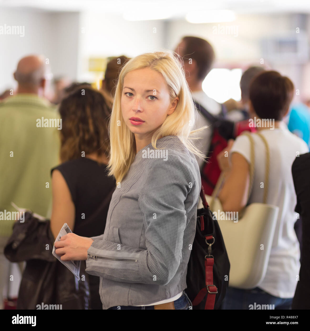 Crowd waiting in line passengers terminal hi-res stock photography and ...