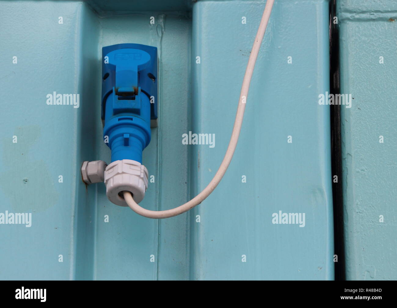 Outdoor Blue Electrical Mount Plug with White Wire Stock Photo - Alamy