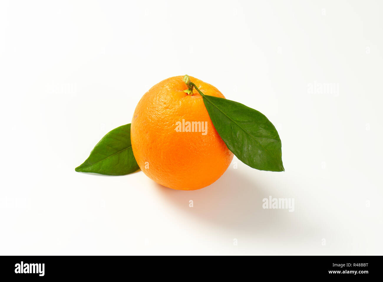 Whole orange with leaves Stock Photo - Alamy