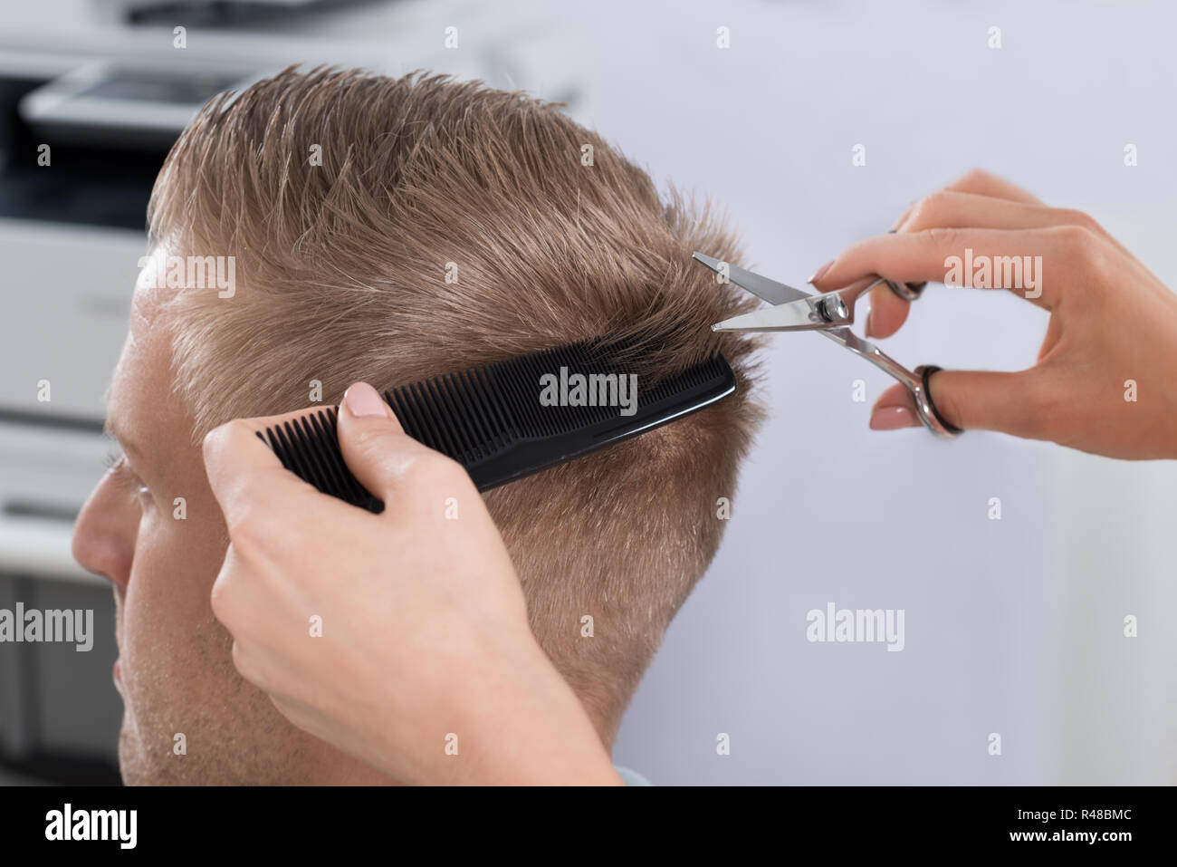 Man Getting Haircut From Hairdresser At Salon Stock Photo - Alamy
