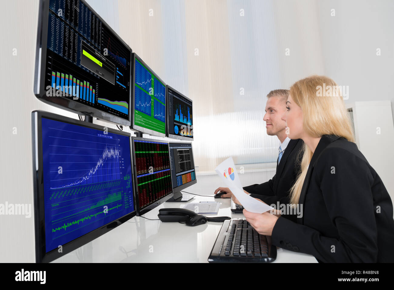 Business People Analyzing Data Displayed On Computer Screens Stock ...