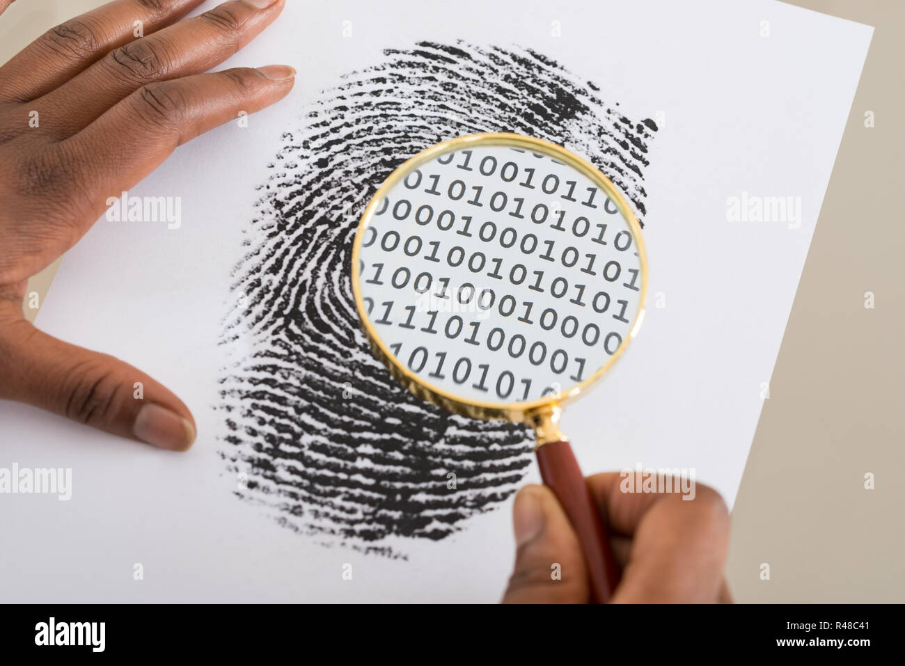 Using Magnifying Glass To Check Binary Code Within Finger Print Stock ...
