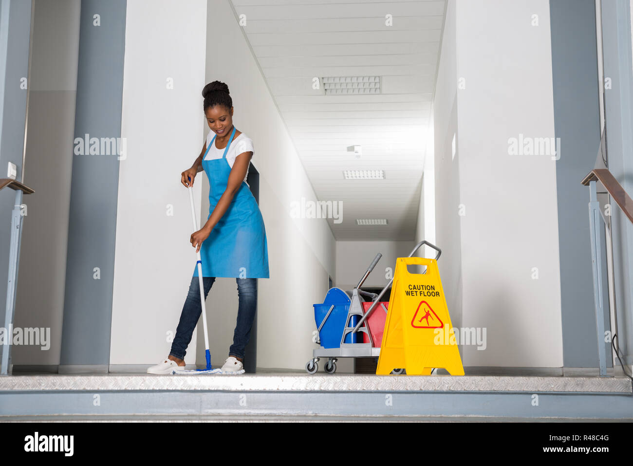 Woman Mopping Corridor Stock Photo - Alamy