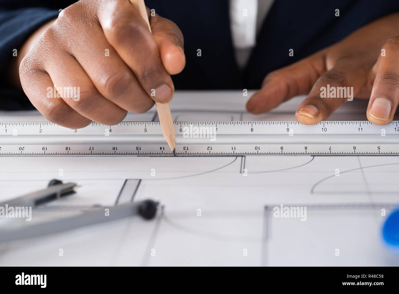 Person's Hand Drawing Blue Print Stock Photo - Alamy