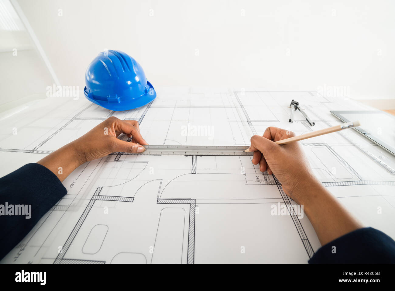 Person's Hand Using Pencil To Draw Blueprint Stock Photo - Alamy