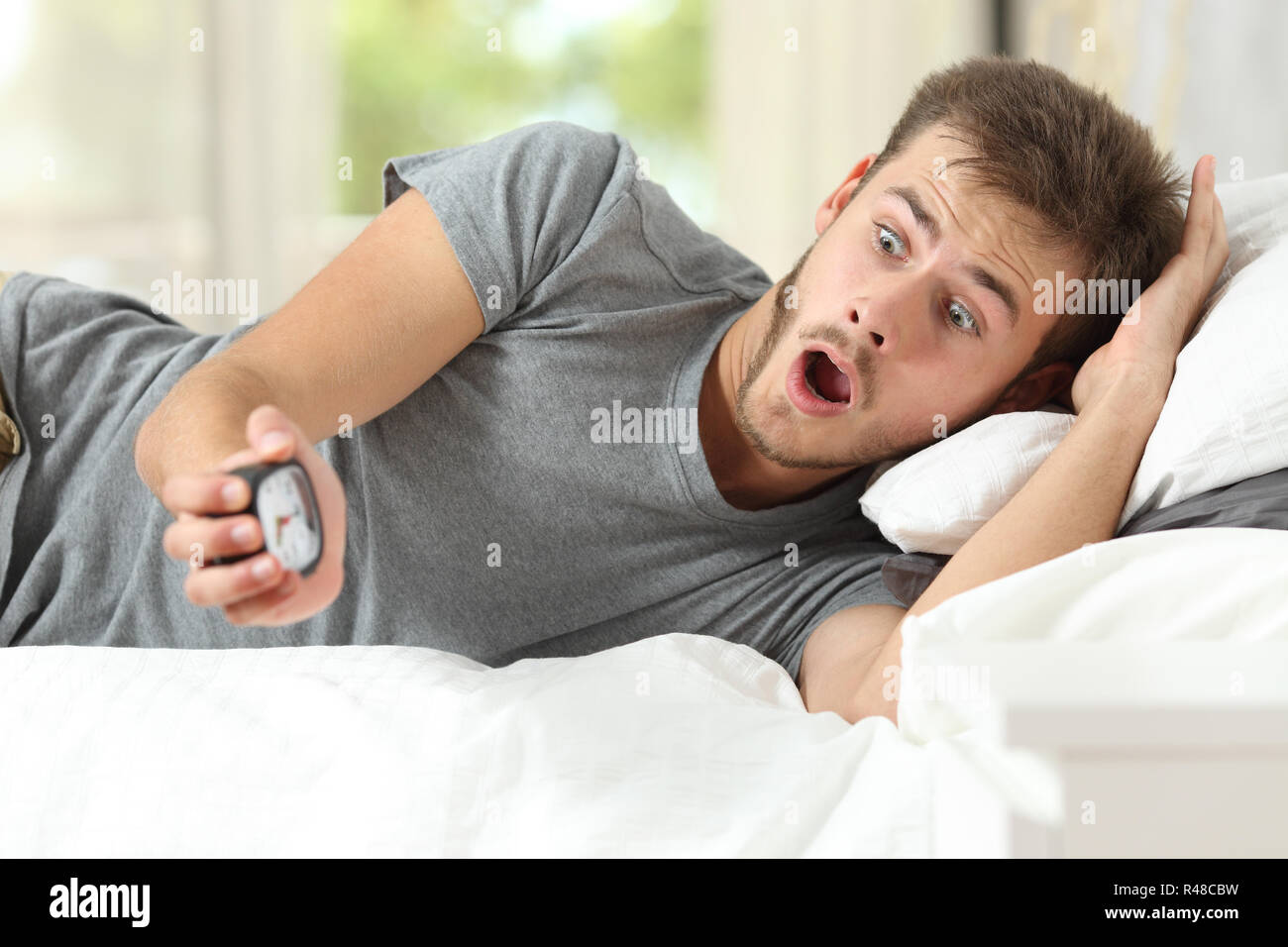 Worried man running out of time in the morning Stock Photo - Alamy