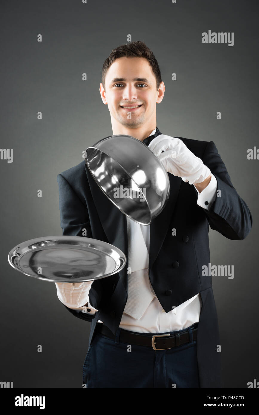 Portrait Of Waiter Holding Cloche Over Empty Tray Stock Photo - Alamy