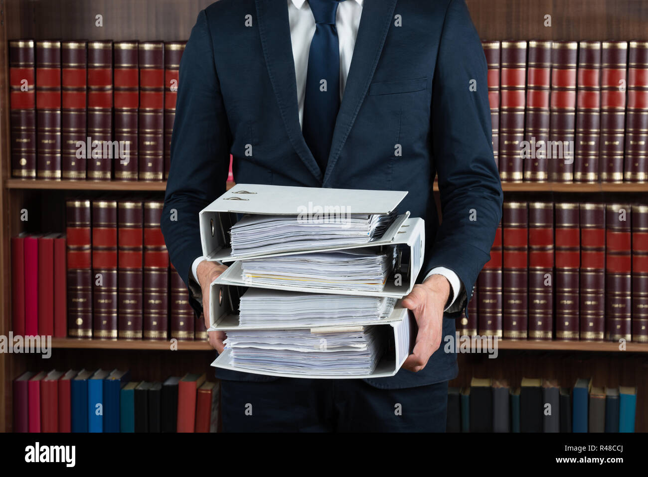 Lawyer Carrying Stack Of Ring Binders Stock Photo - Alamy