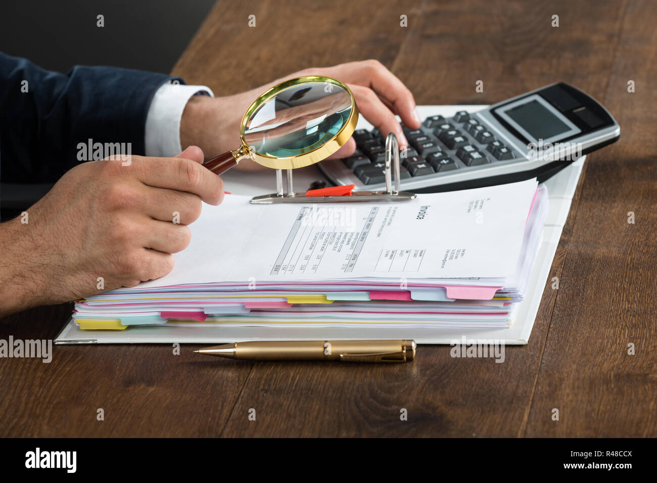 Businessman Checking Invoice With Magnifying Glass Stock Photo - Alamy