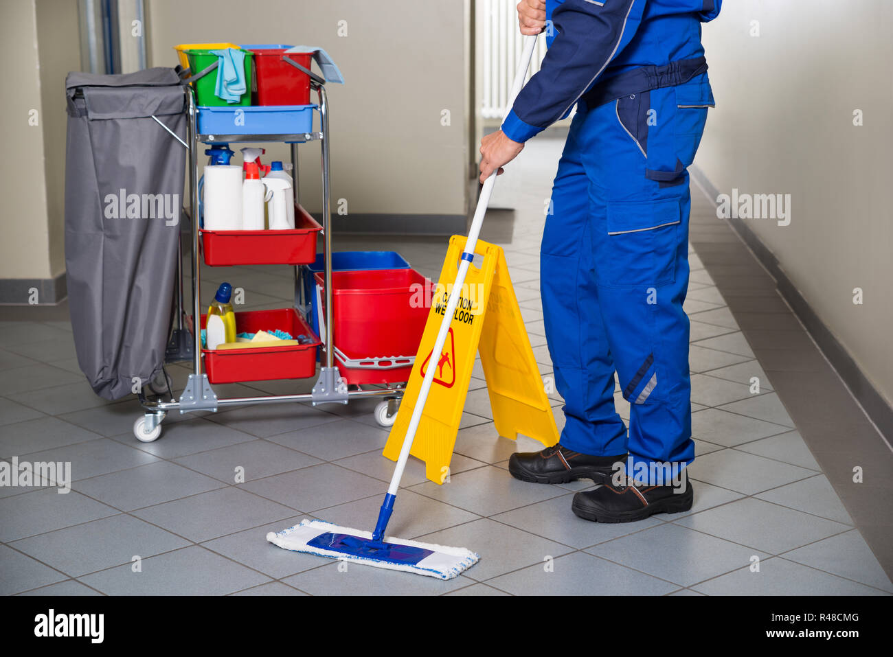 Janitor With Broom Cleaning Office Corridor Stock Photo - Alamy