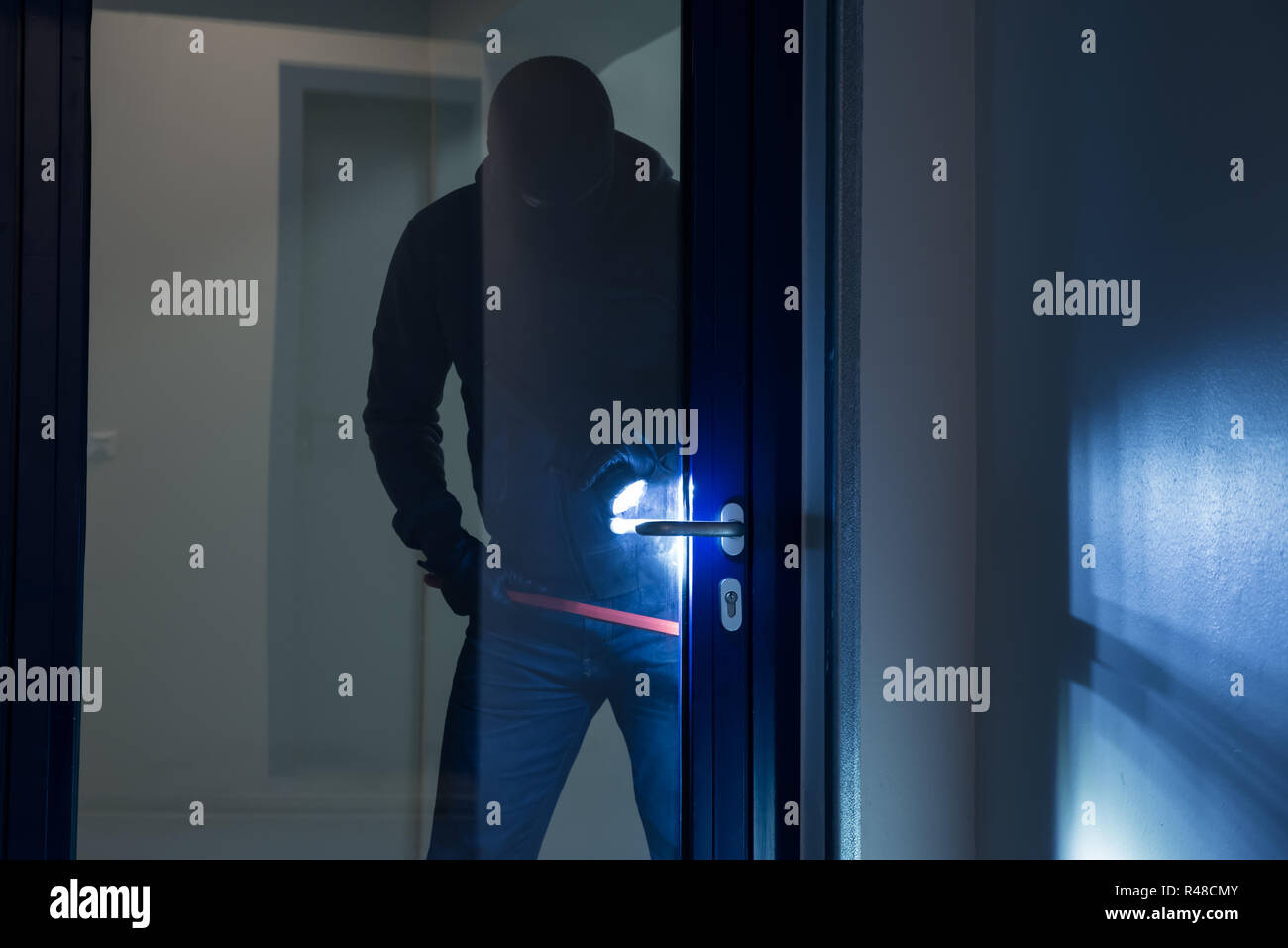 Burglar Using Crowbar To Open Glass Door Stock Photo - Alamy