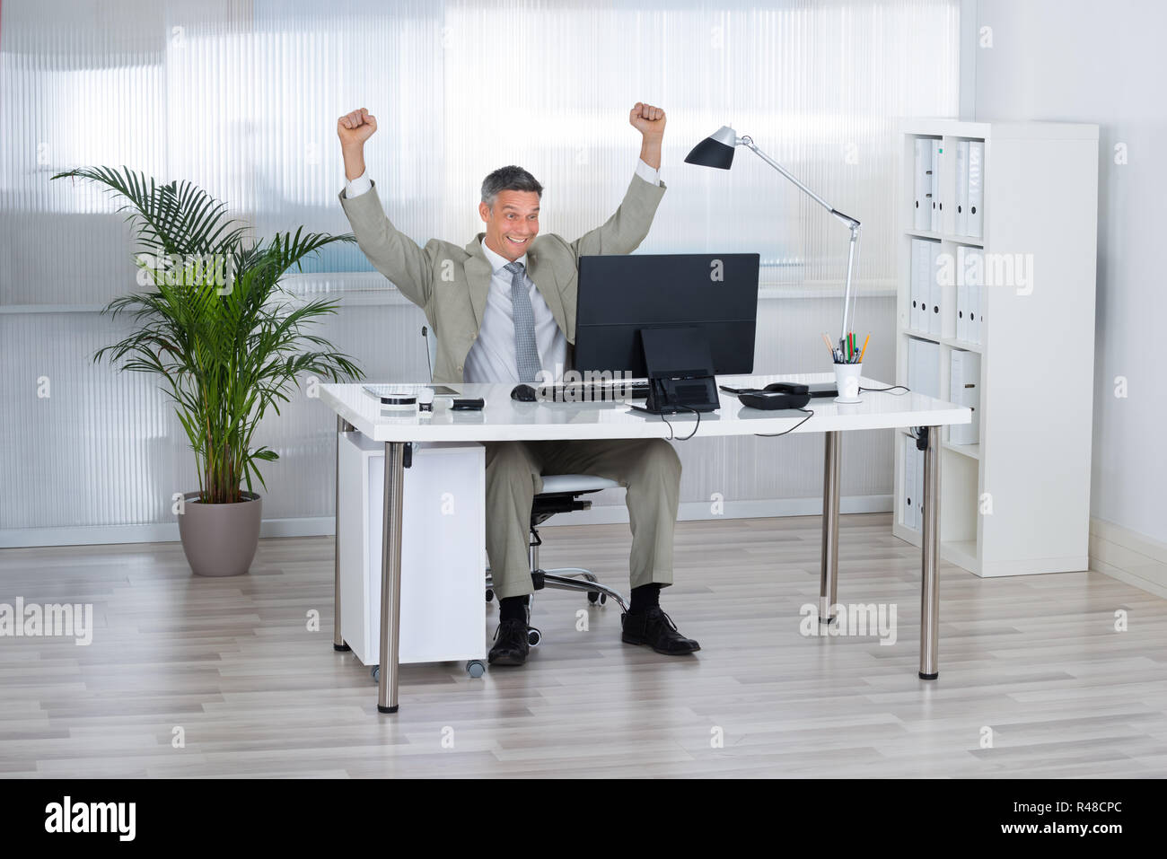 Succesful businessman sitting desk hi-res stock photography and images ...